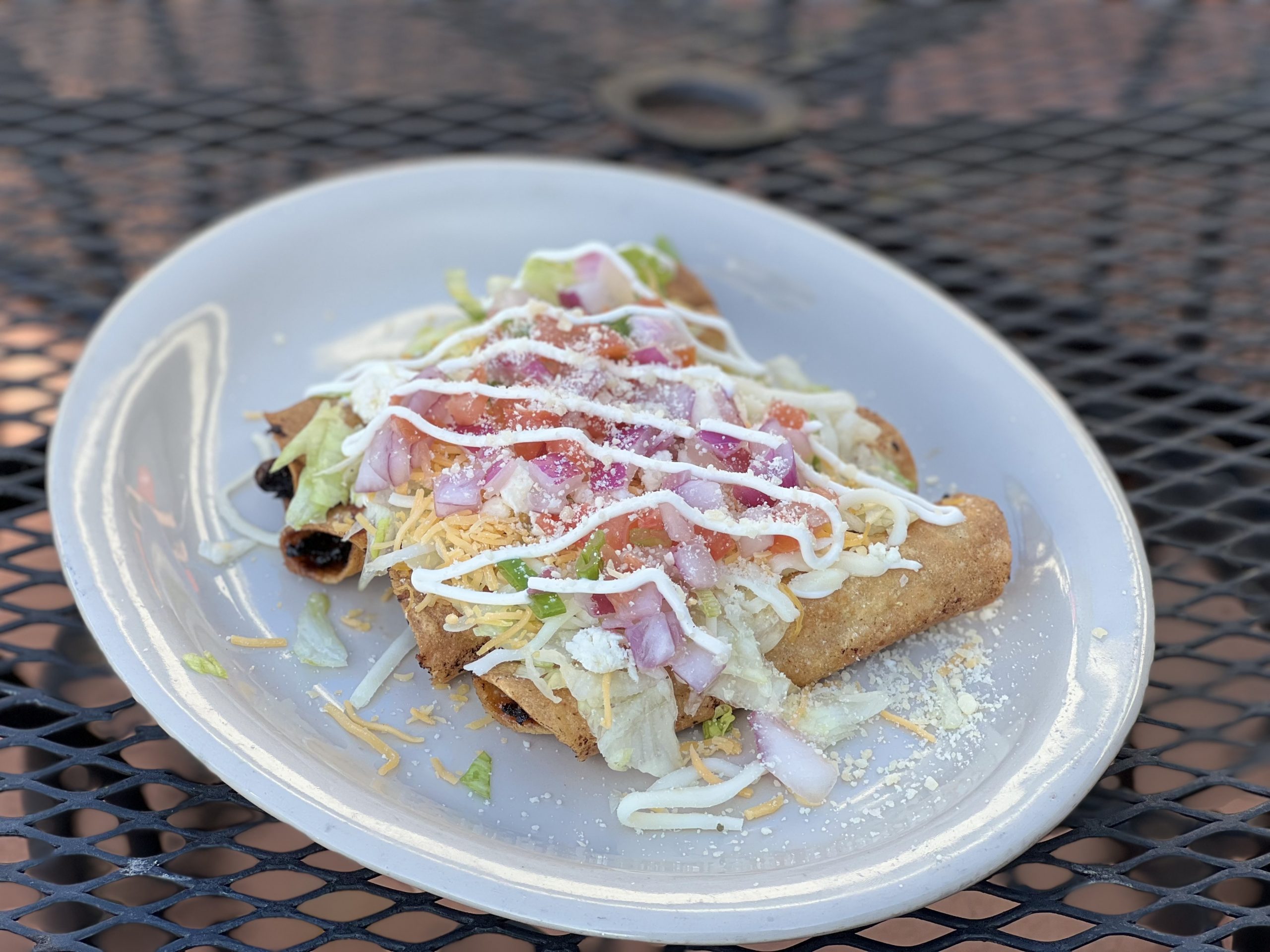 Mexican puff pastry stuffed with avocado and topped with cheese sauce ...